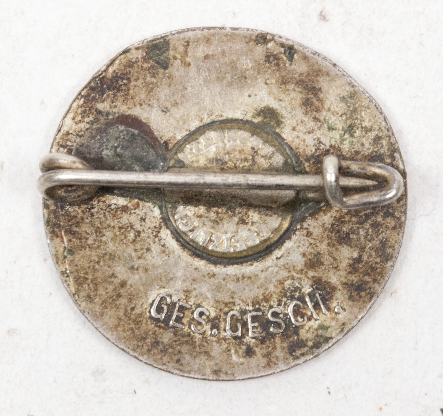 (Slogan) Full size NSDAP “Nun Erst Recht” badge (double Ges Gesch)